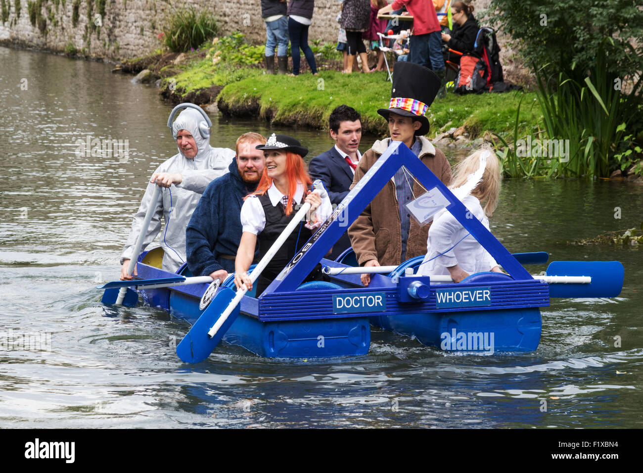 people and home made boats competing in the Wells Moat Boat race, an ...