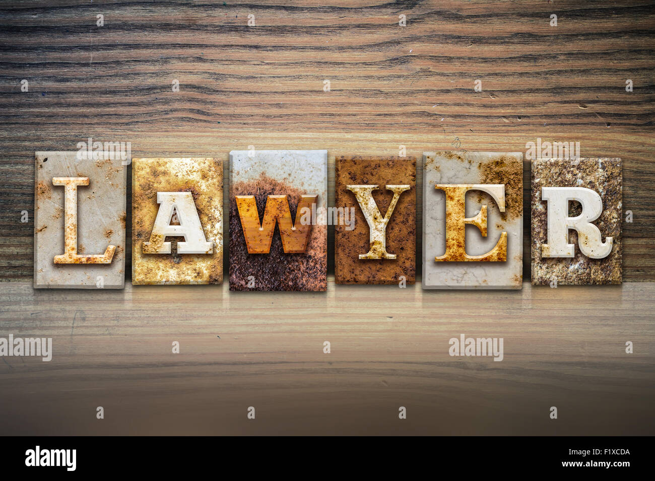 The word "LAWYER" written in rusty metal letterpress type sitting on a ...