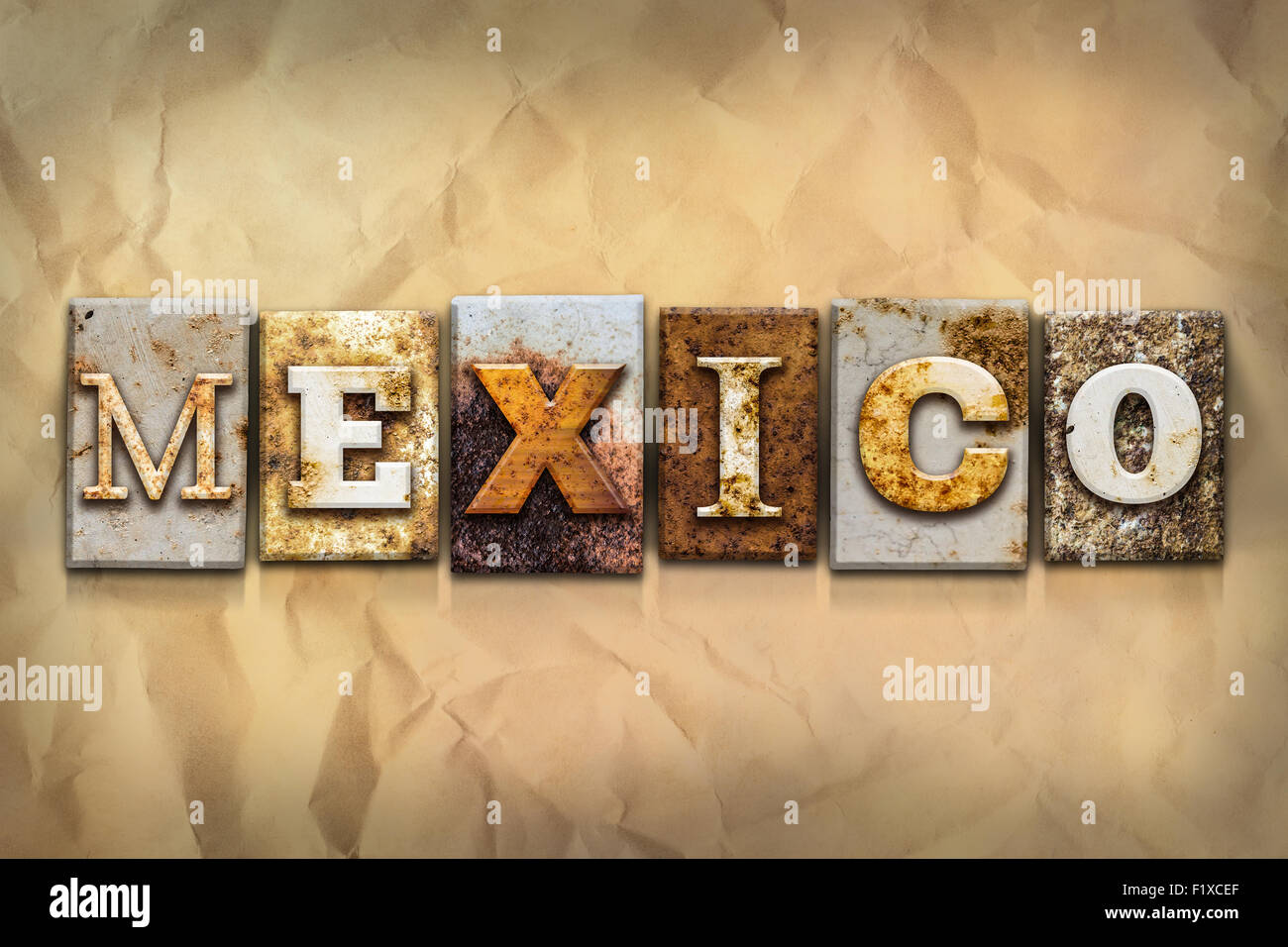 The word "MEXICO" written in rusty metal letterpress type on a crumbled ...