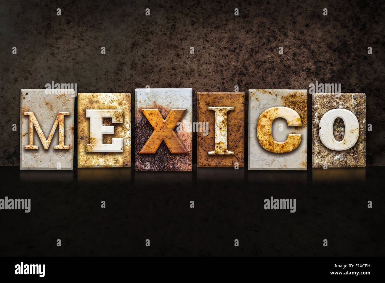 The word "MEXICO" written in rusty metal letterpress type on a dark ...