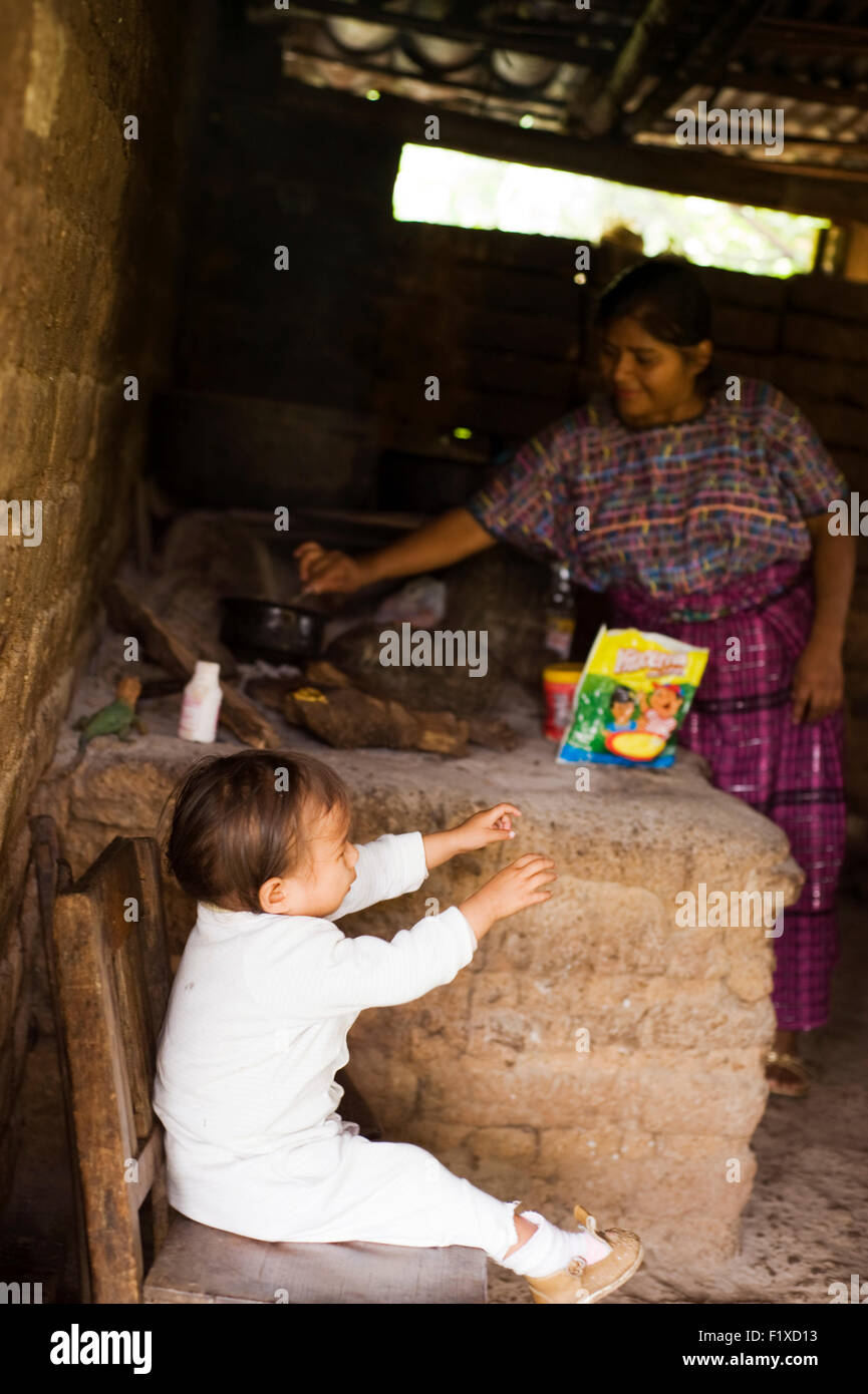 Guatemala, Salama, mother preparing complementary food for baby (Maria ...