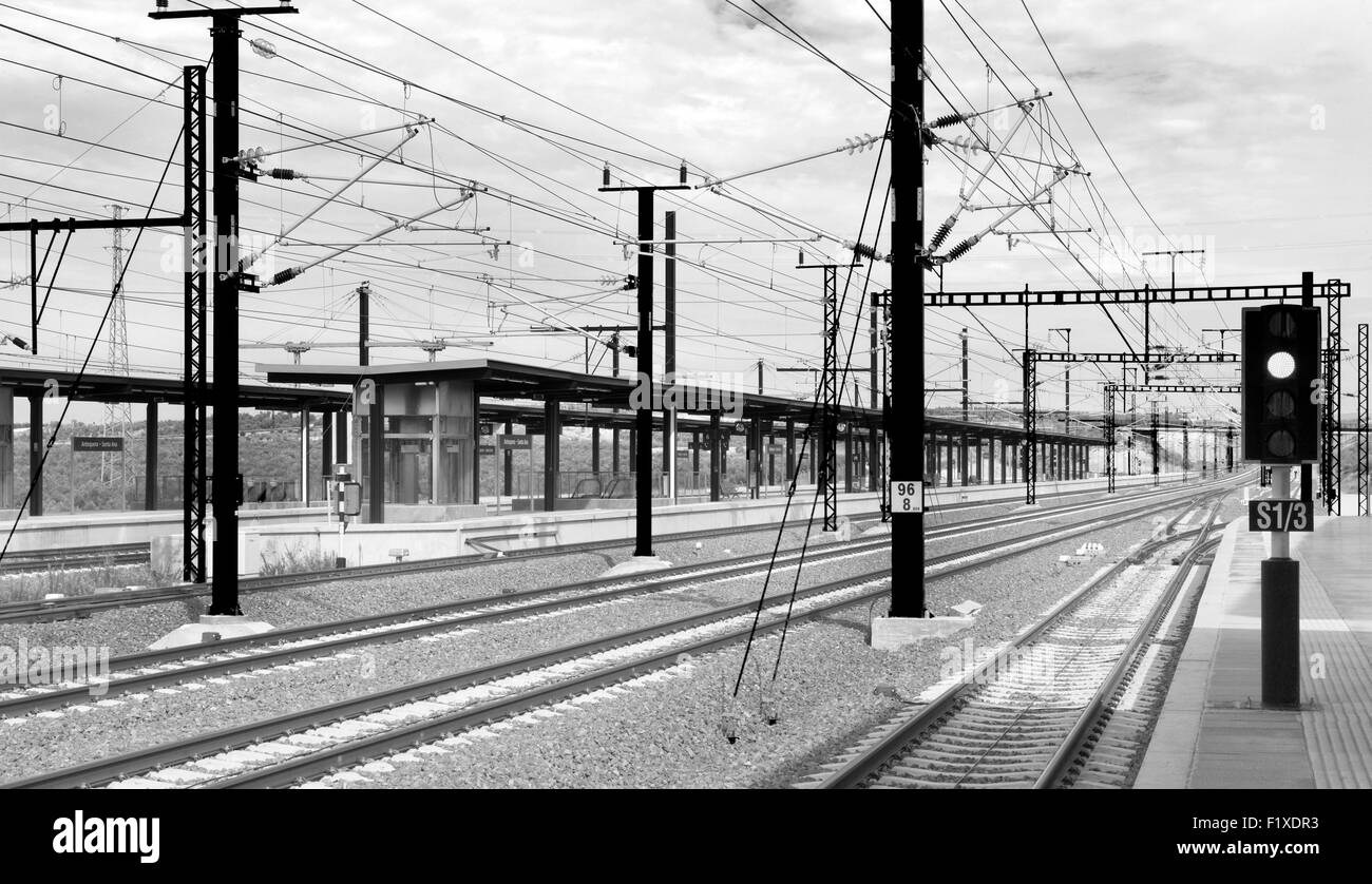 Railway with electric posts and platforms black and white Stock Photo ...