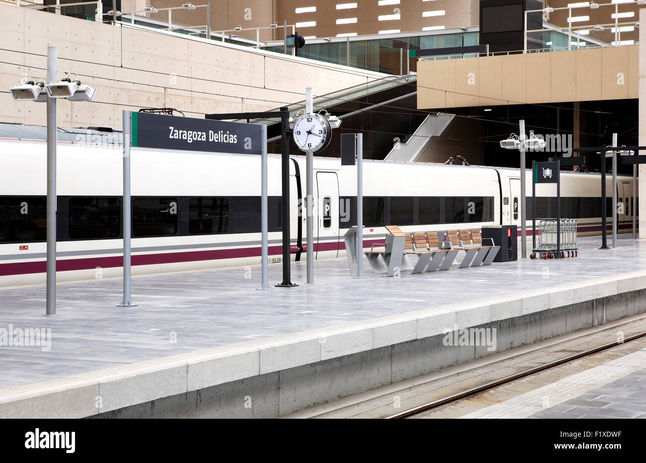 Railway station with high speed train signpost and clock Stock Photo ...