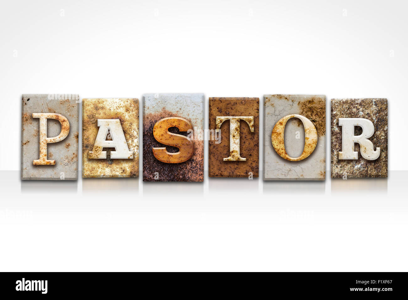 The word "PASTOR" written in rusty metal letterpress type isolated on a ...