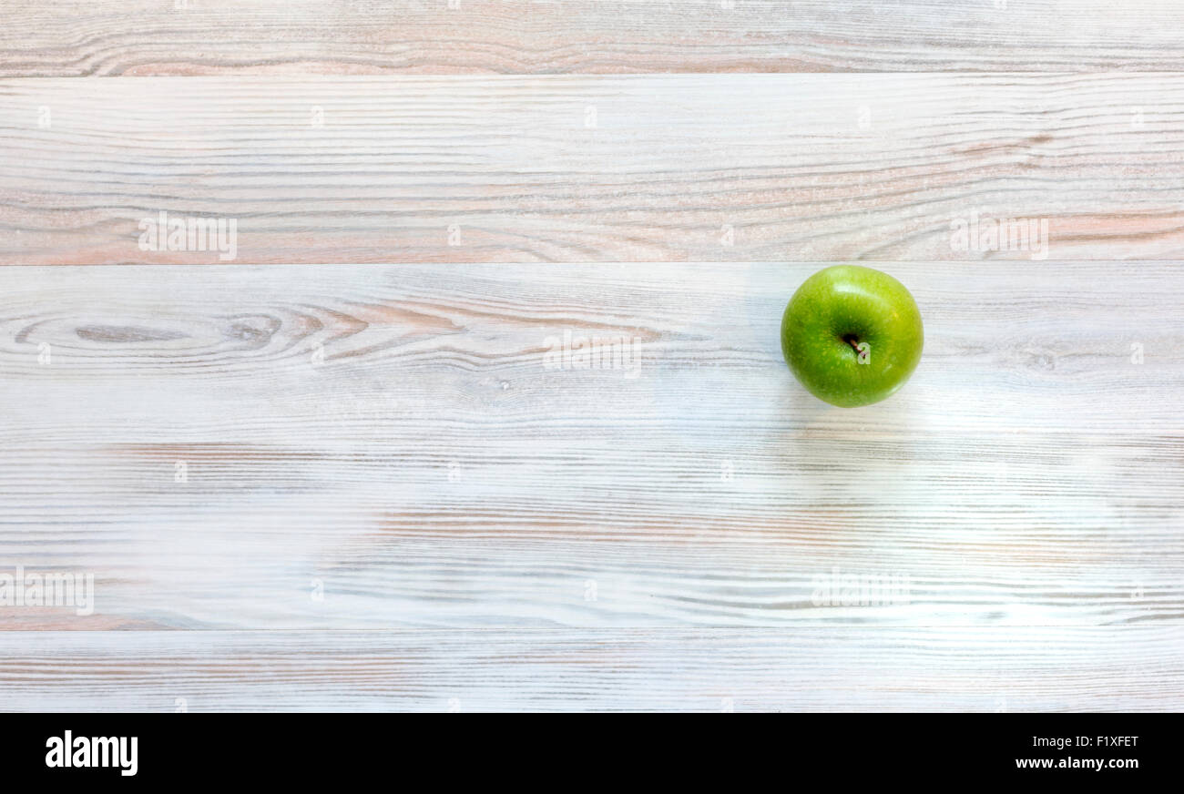 Green apple on wood background Stock Photo - Alamy