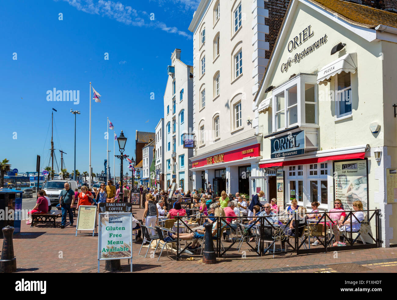 People sitting outside The Quay pub and Oriel Cafe on The Quay in Poole ...