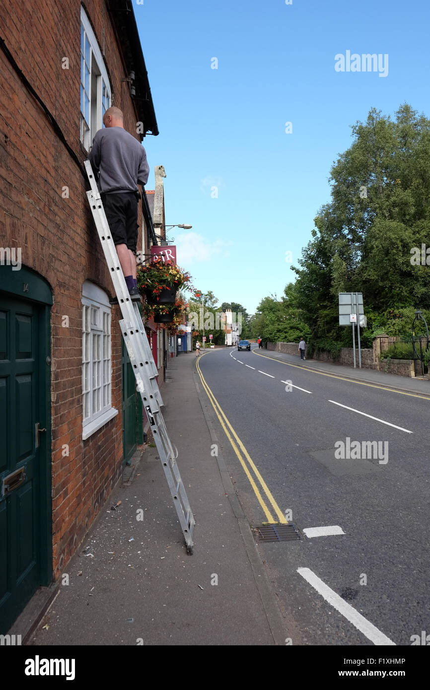 Man up ladder hi-res stock photography and images - Alamy