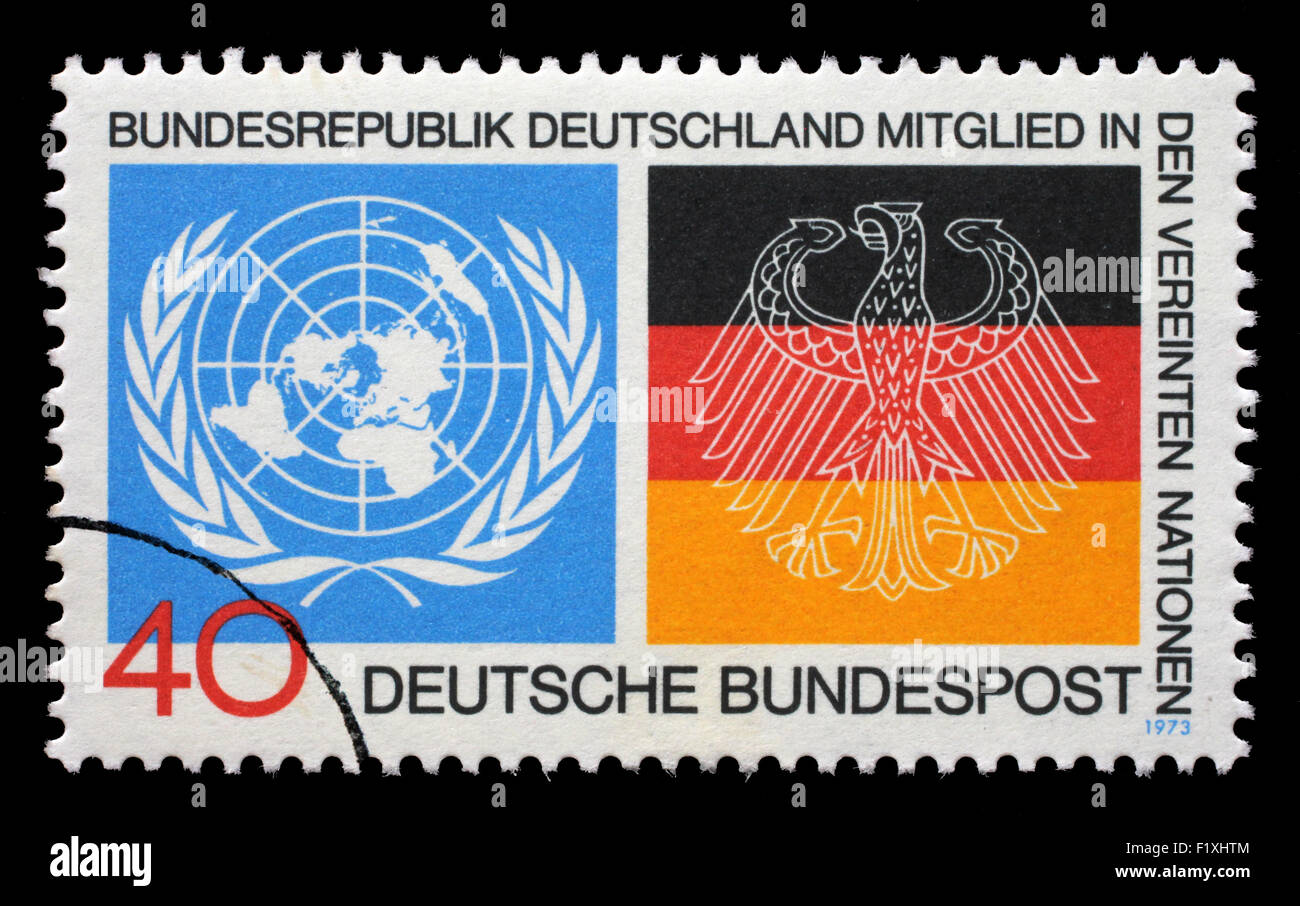 Stamp printed in the Germany shows Emblems from UN and German Flags ...