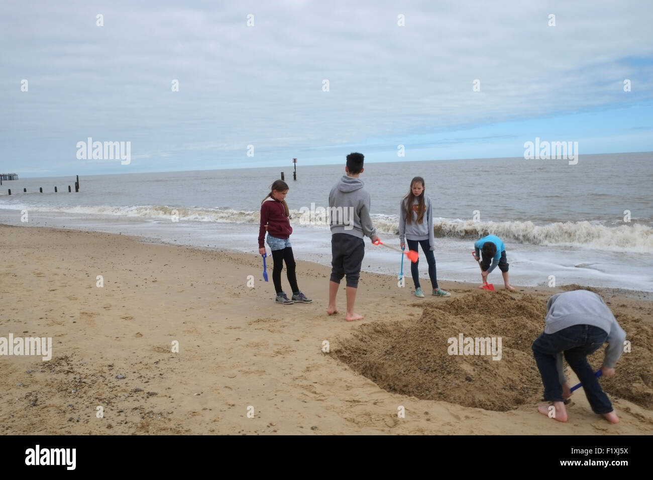 children building structures in the sand at the beach in Uk Stock Photo ...