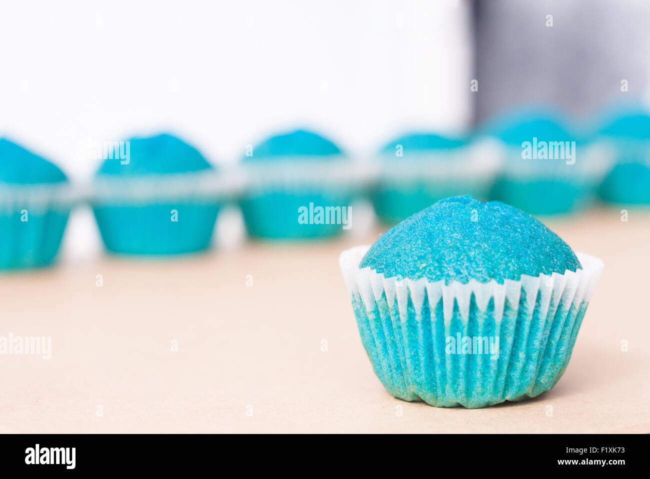 Several red velvet muffins stand in a row in the background Stock Photo ...