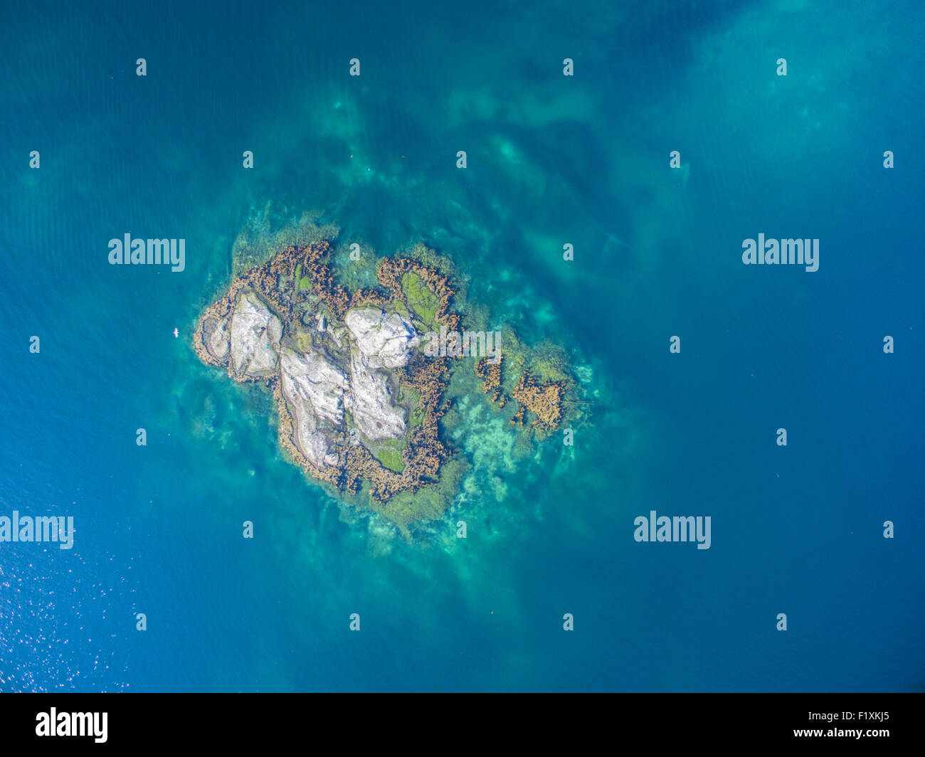 Scenic aerial view of tiny rocky islet in turquoise sea Stock Photo - Alamy
