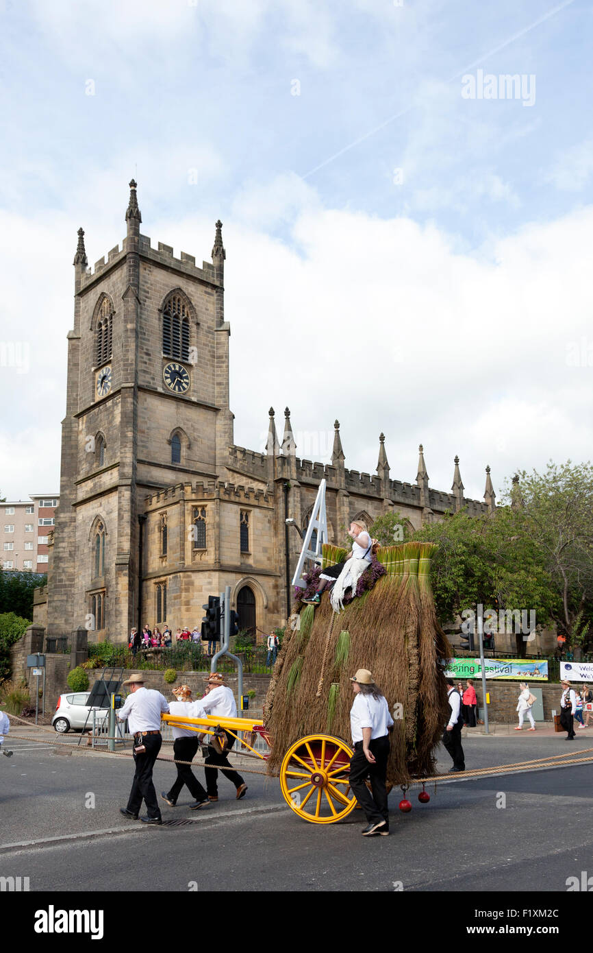 Men pulling the rushcart past Christ Church in the Rushbearing festival ...