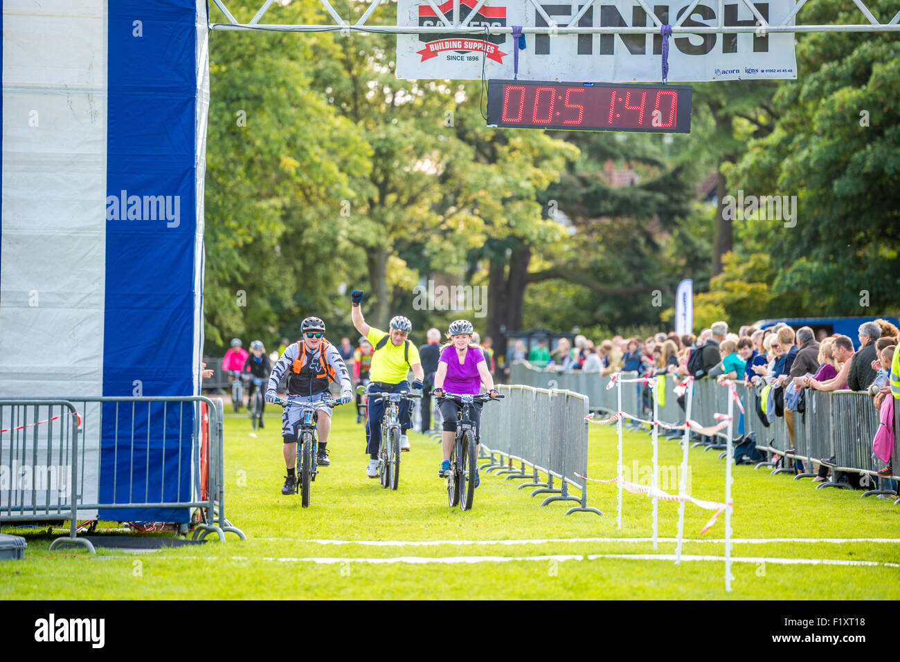 Three cyclists finishing the 20k bike ride at The Carvers sponsored ...