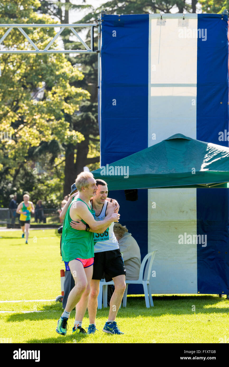 Two men hugging after finishing the 10k run at The Carvers sponsored ...