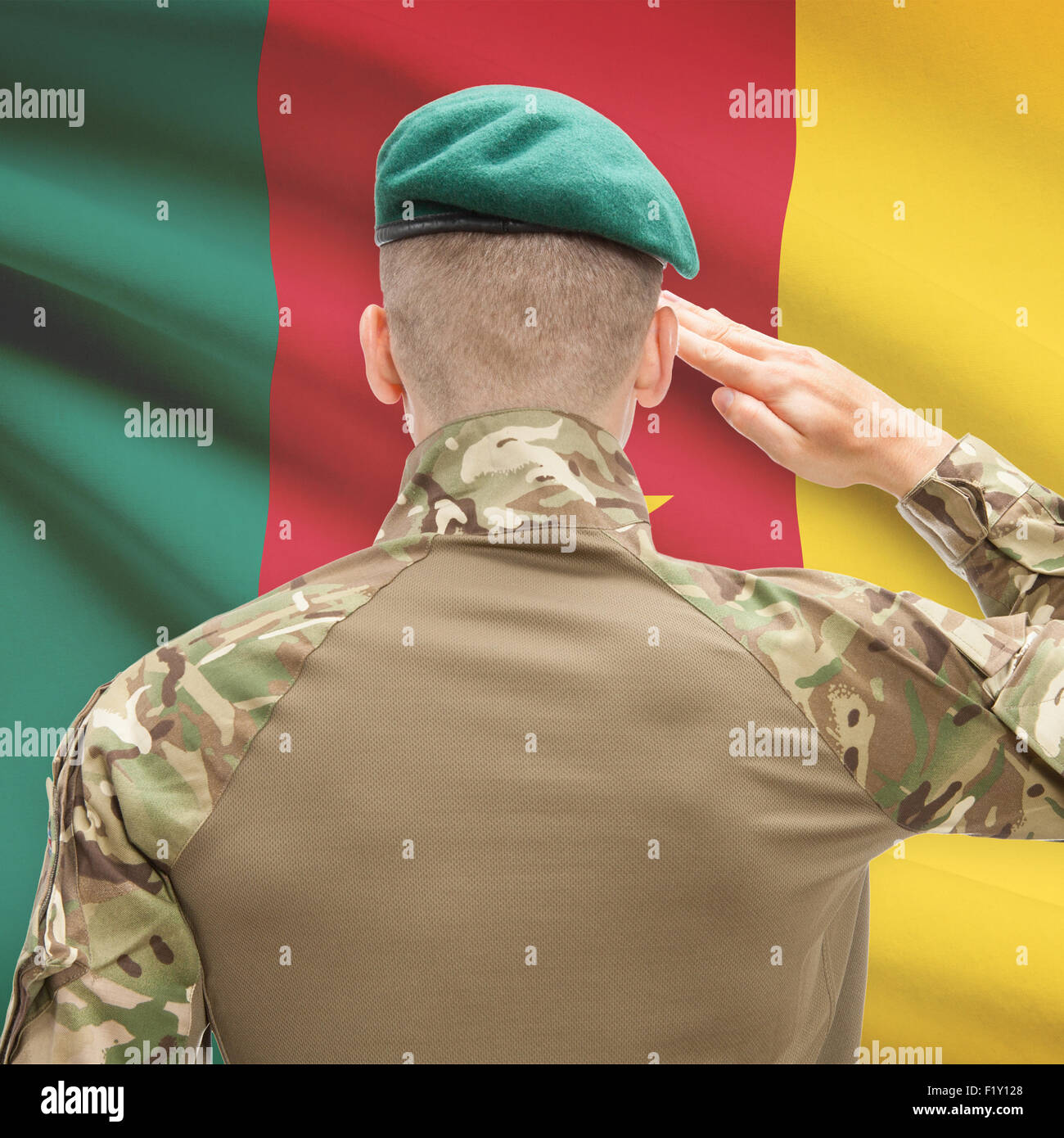 Soldier in hat facing national flag series - Cameroon Stock Photo - Alamy