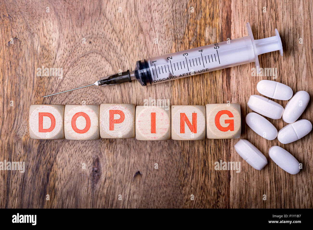 doping written with syringe and pills on wood Stock Photo - Alamy