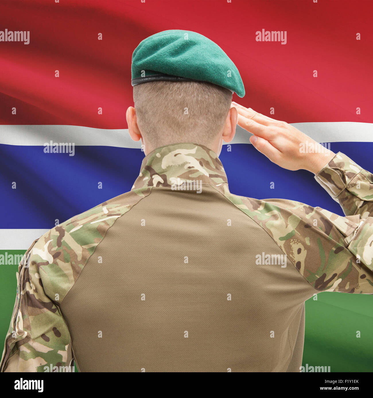 Soldier in hat facing national flag series - Gambia Stock Photo - Alamy