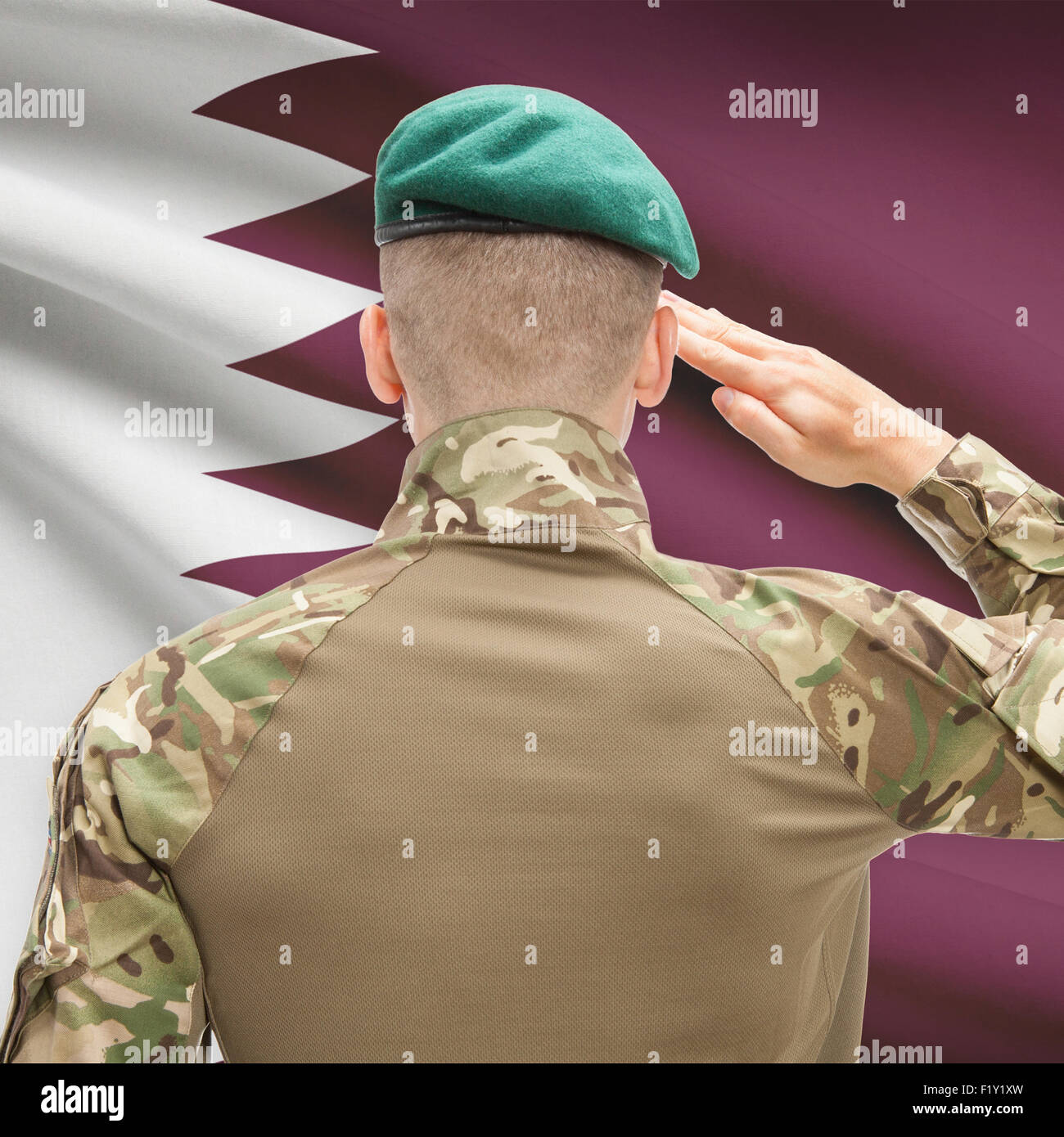 Soldier in hat facing national flag series - Qatar Stock Photo - Alamy