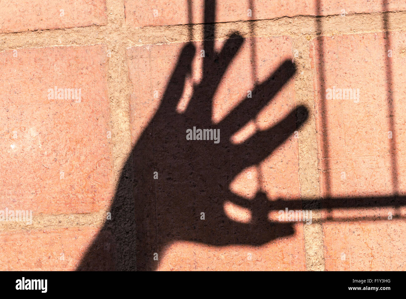 Rectilinear and hand shadows on a clay tile an outdoor terrace Stock ...