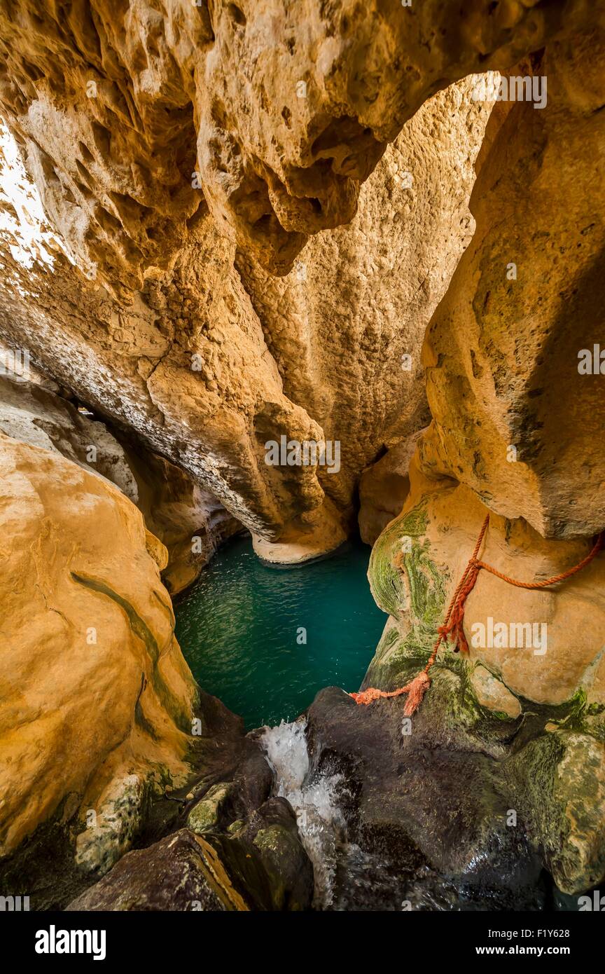 oman-wadi-shab-waterfall-in-the-cave-at-the-end-of-the-canyon-stock