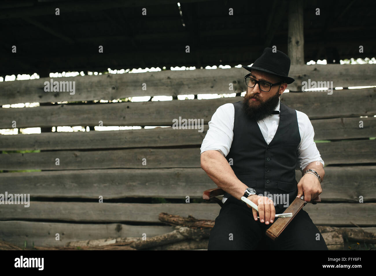 strong man sharpens old razor Stock Photo - Alamy