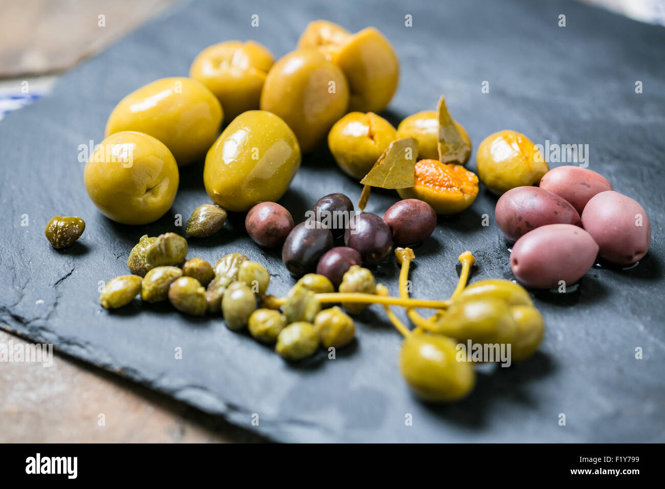 Mixed olives on grey background Stock Photo - Alamy