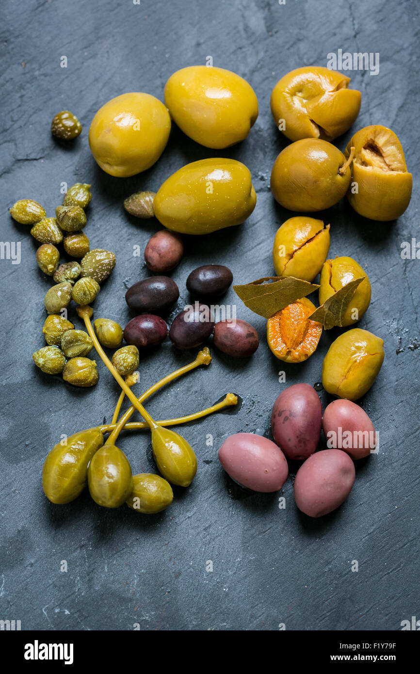 Mixed olives on grey background Stock Photo - Alamy