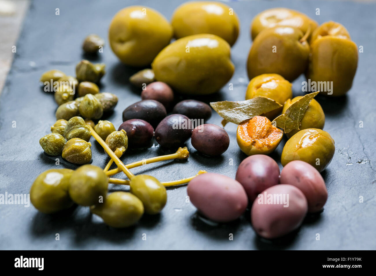Mixed olives on grey background Stock Photo - Alamy