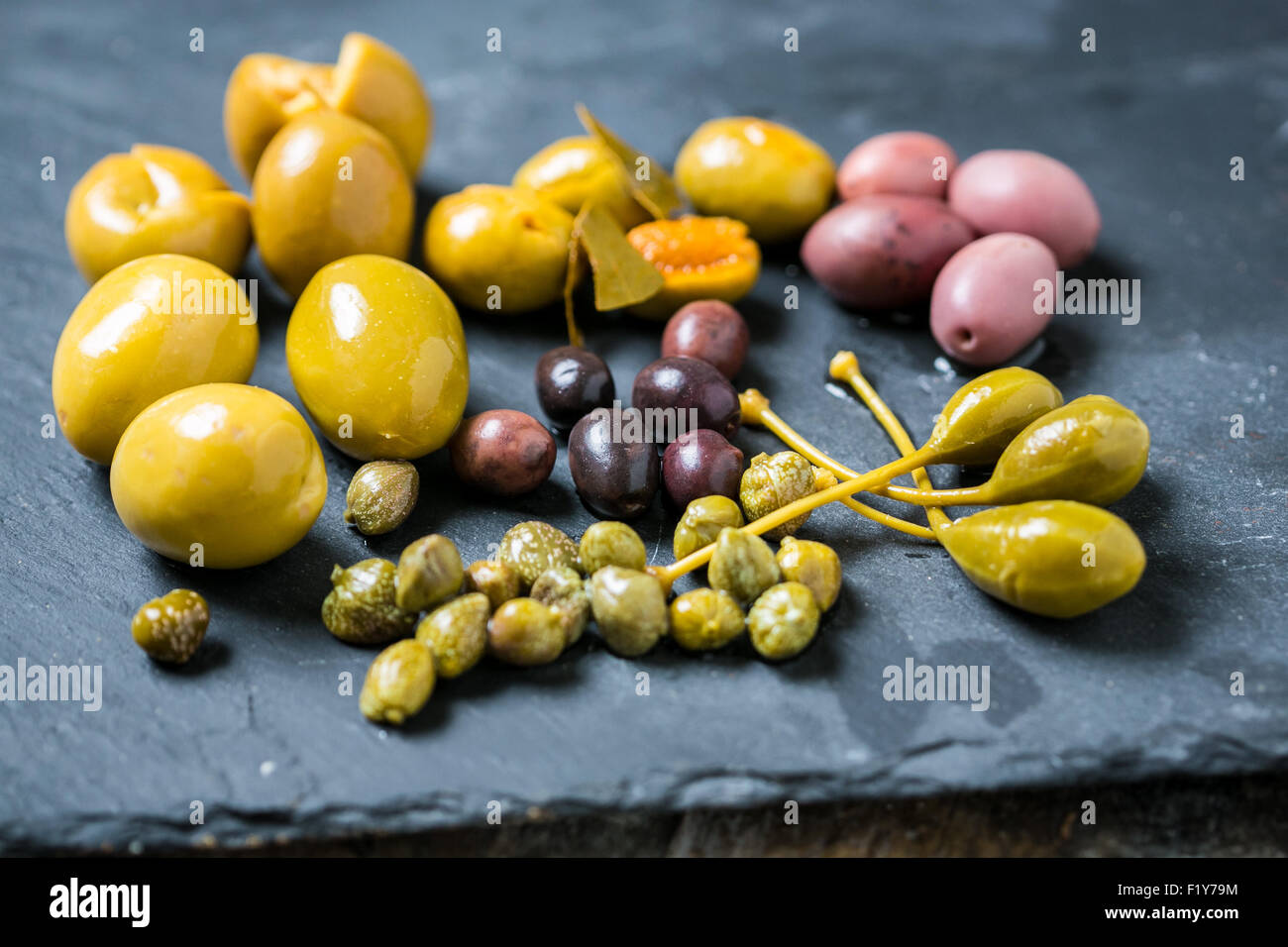 Mixed olives on grey background Stock Photo - Alamy