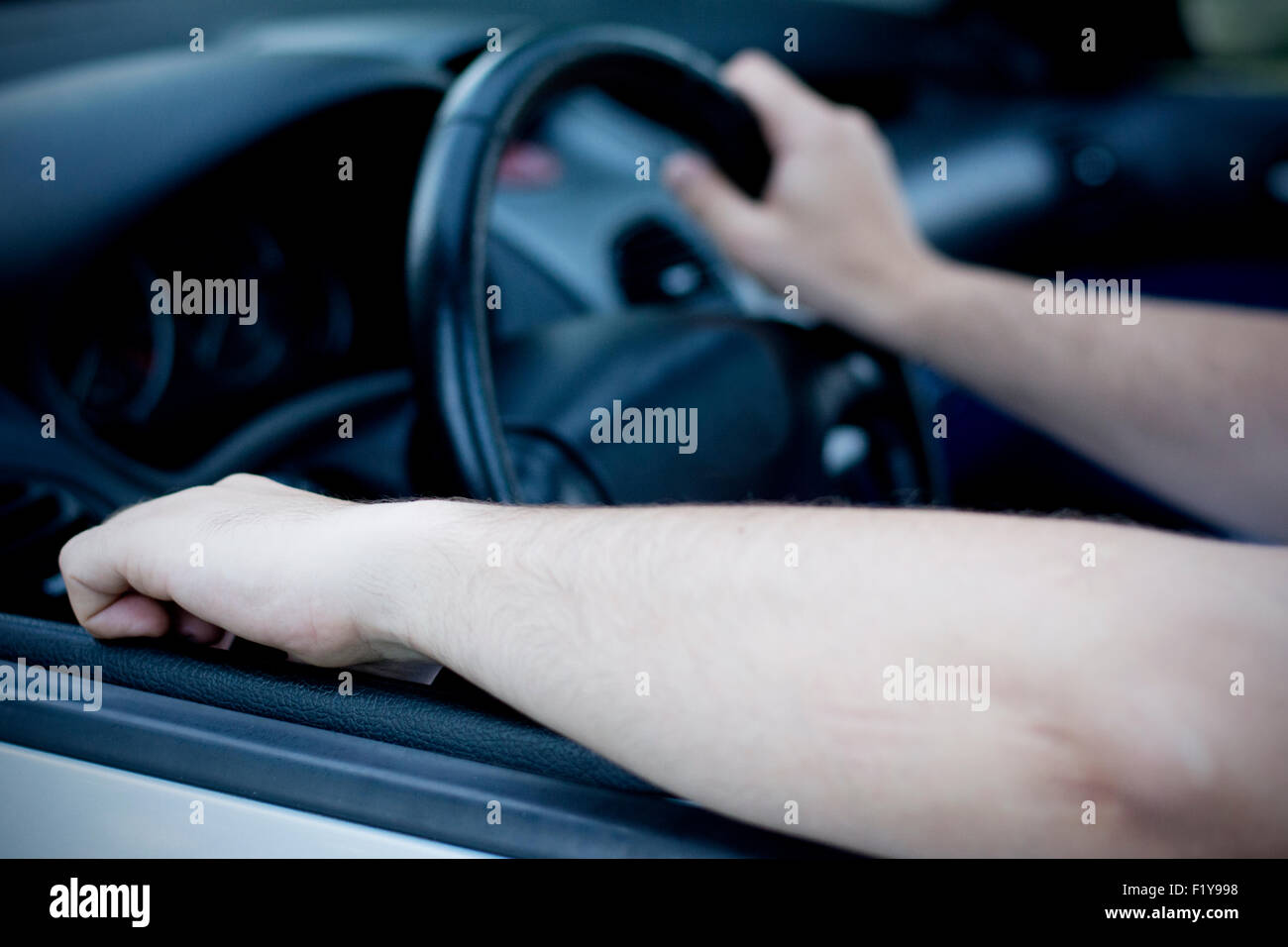 Male hands drive car holding hi-res stock photography and images - Alamy