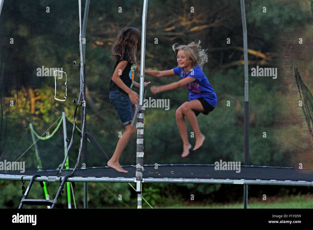 Two Happy Girls Jumping On High Resolution Stock Photography and Images ...