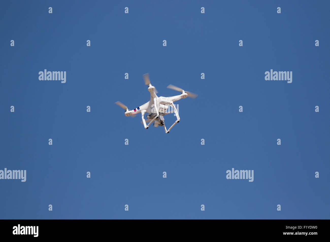 Drone flying against a vivid blue sky Stock Photo - Alamy