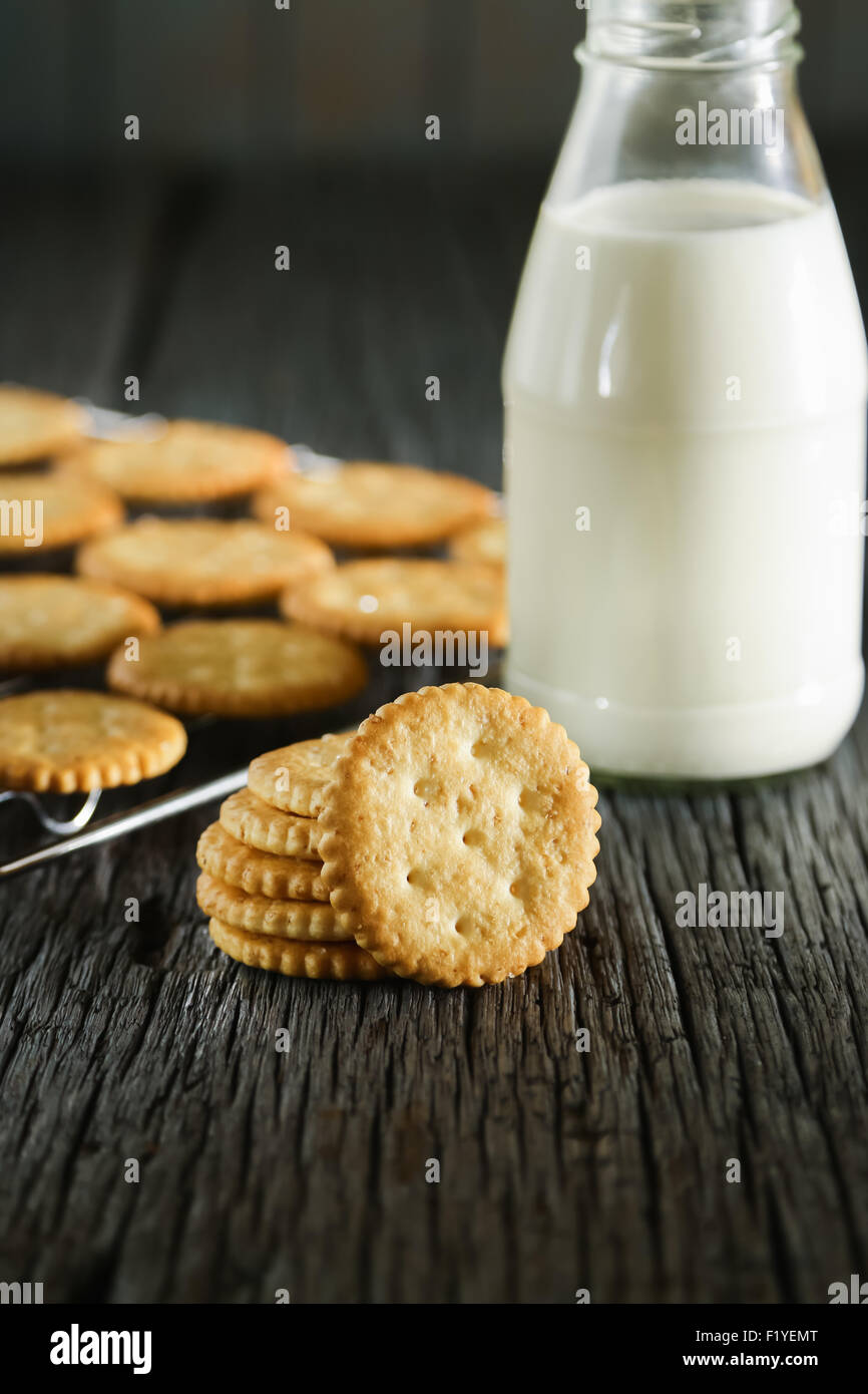 Delicious biscuits with milk on a wooden table Stock Photo - Alamy