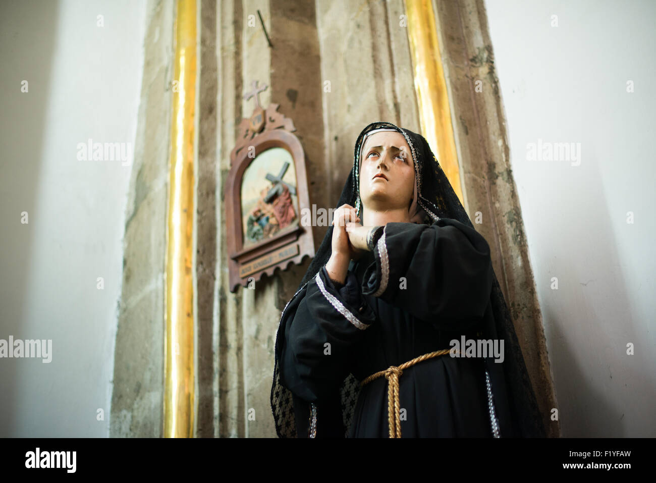 MEXICO CITY, Mexico — A statue of a nun with upturned face and clasped ...