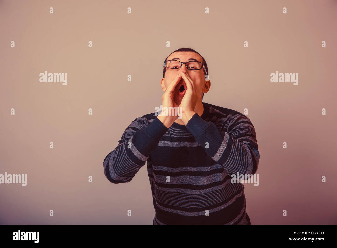 European-looking man of 30 years with glasses, calling, shouting Stock ...