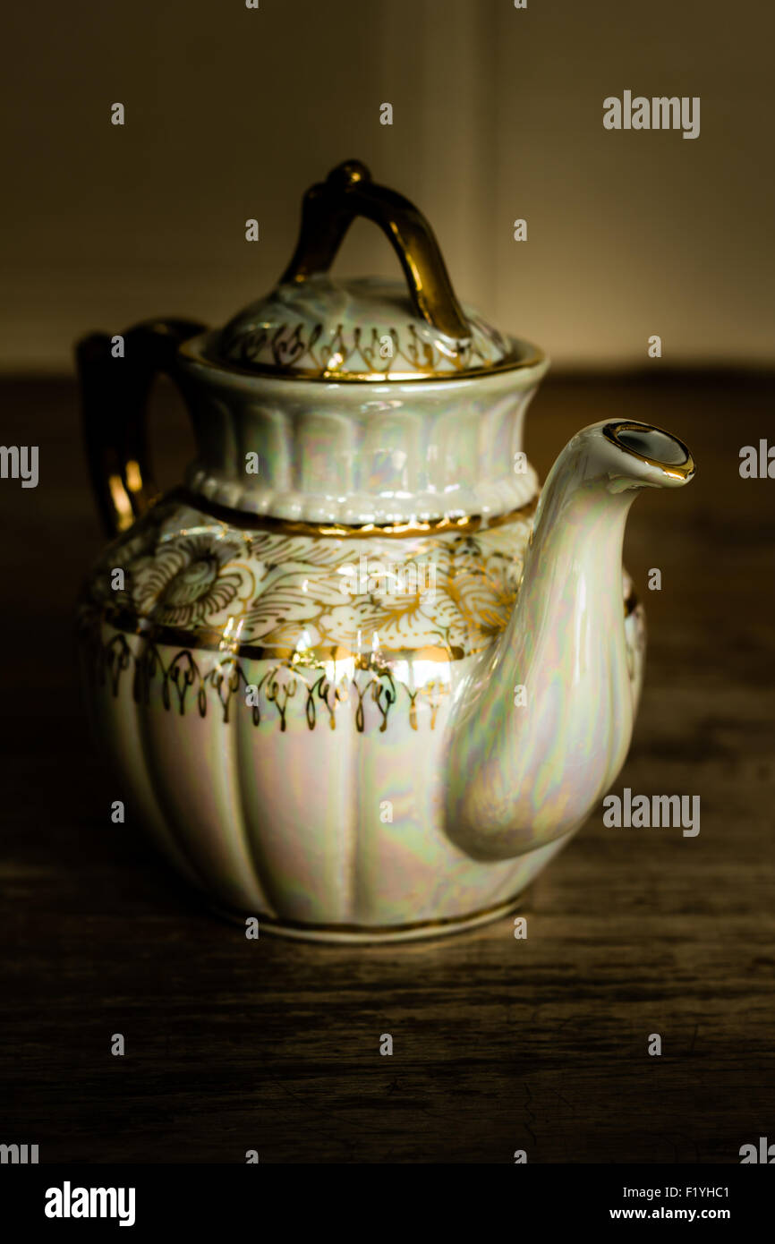 Still life with teapot on wooden table over grunge background Stock ...