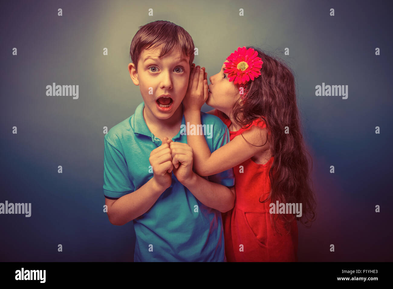 Teenage girl whispering in the ear of a secret teen boys on a Stock ...