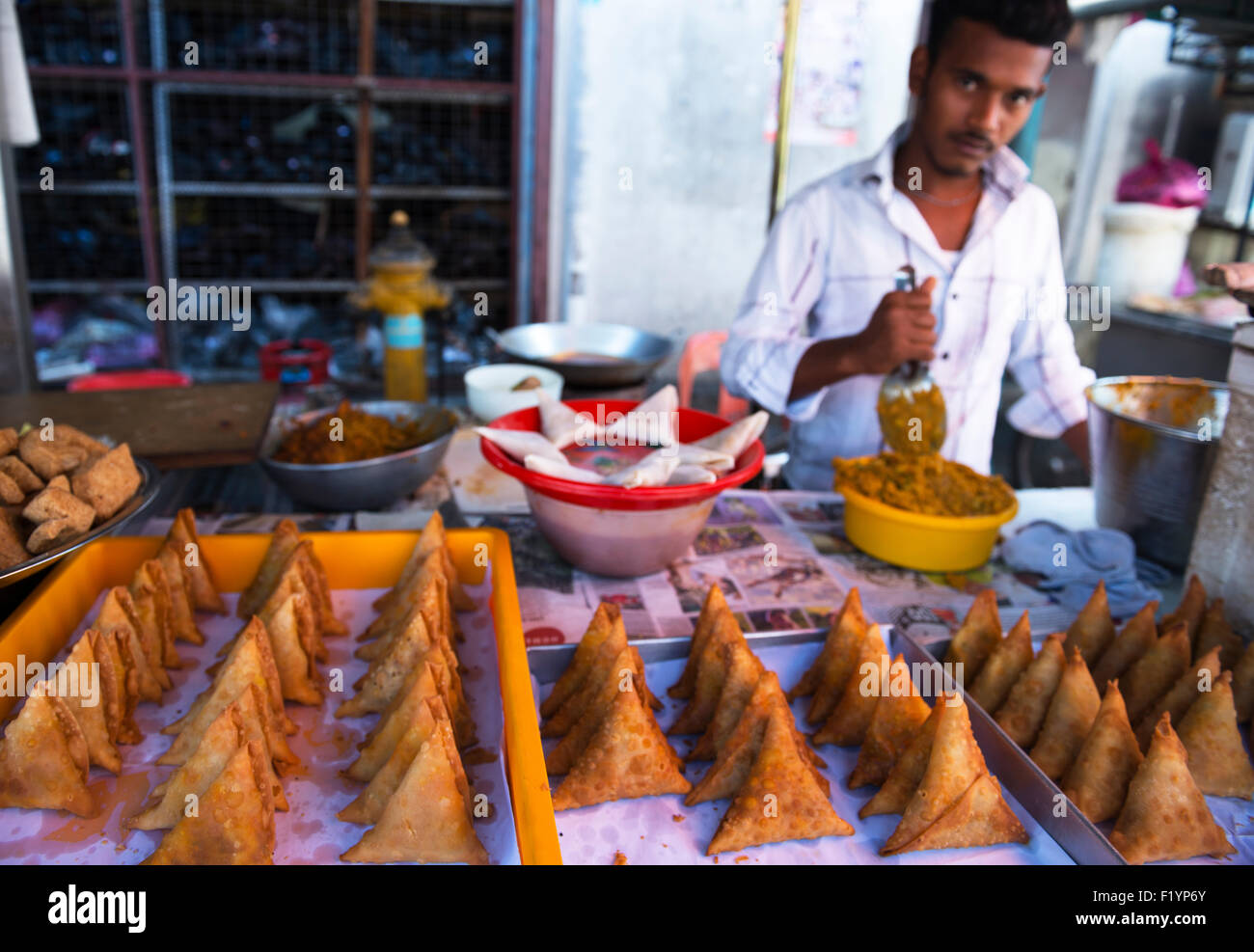 A Tamil man making Samosas in a small stall in the streets of ...