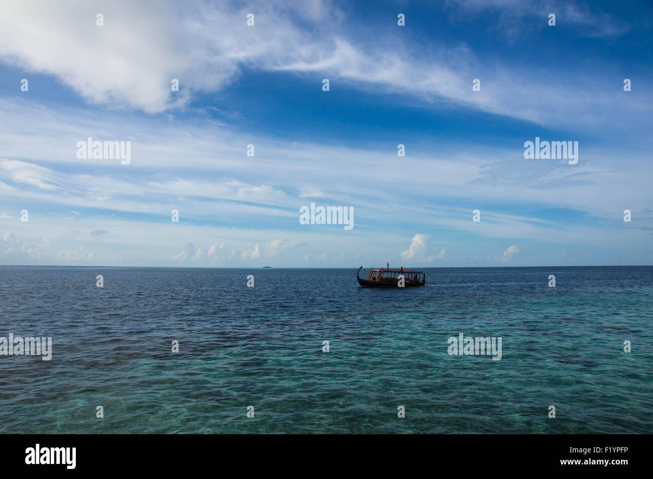 Boat floating on the ocean on a cloudy day Stock Photo - Alamy