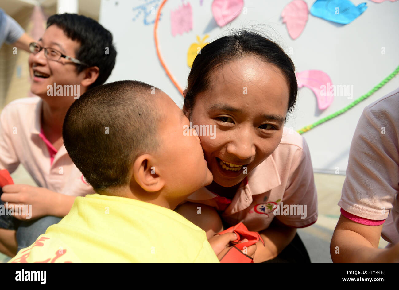Hefei, China's Anhui Province. 9th Sep, 2015. An autistic child kisses ...