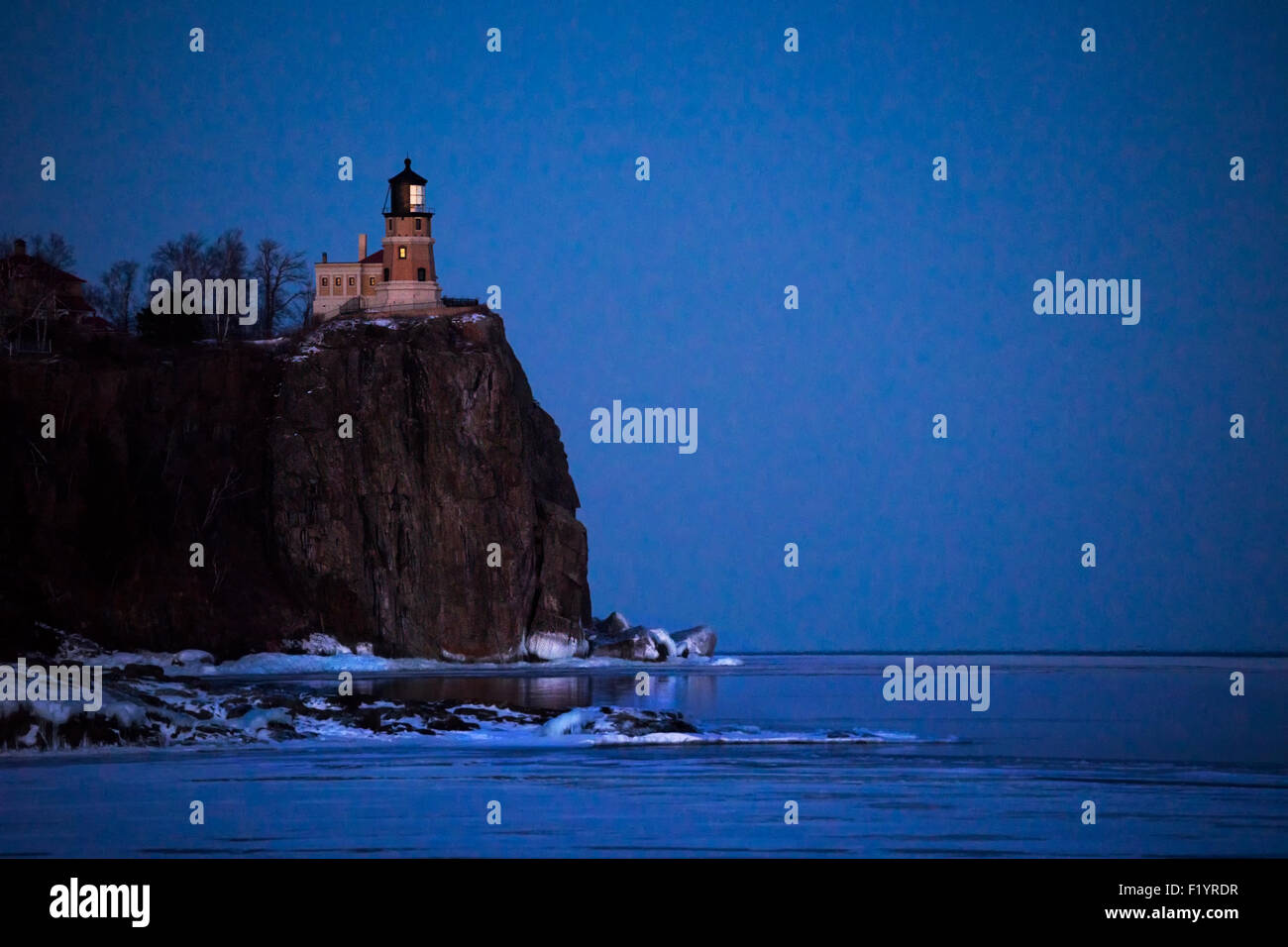 Split Rock Lighthouse perched on top of rocky cliff edging Lake ...