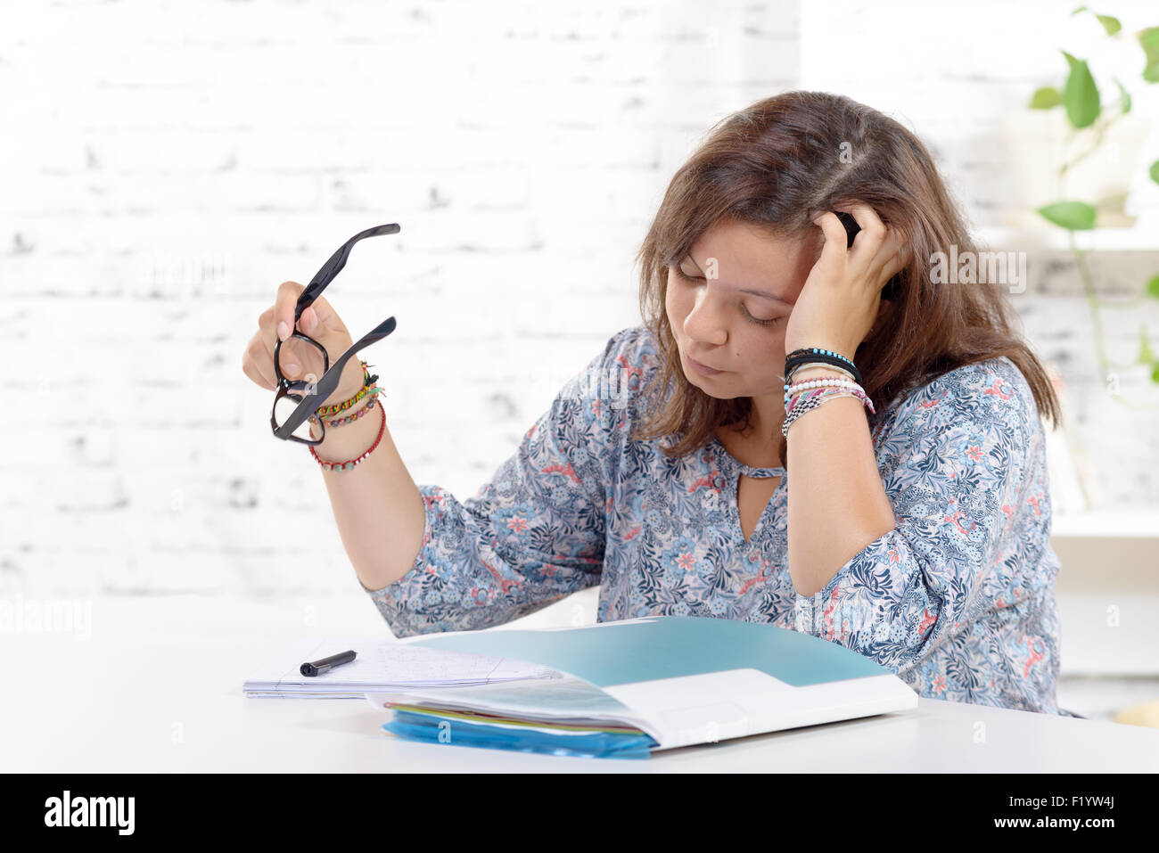 a teenage girl with eyeglasses doing her homework Stock Photo - Alamy