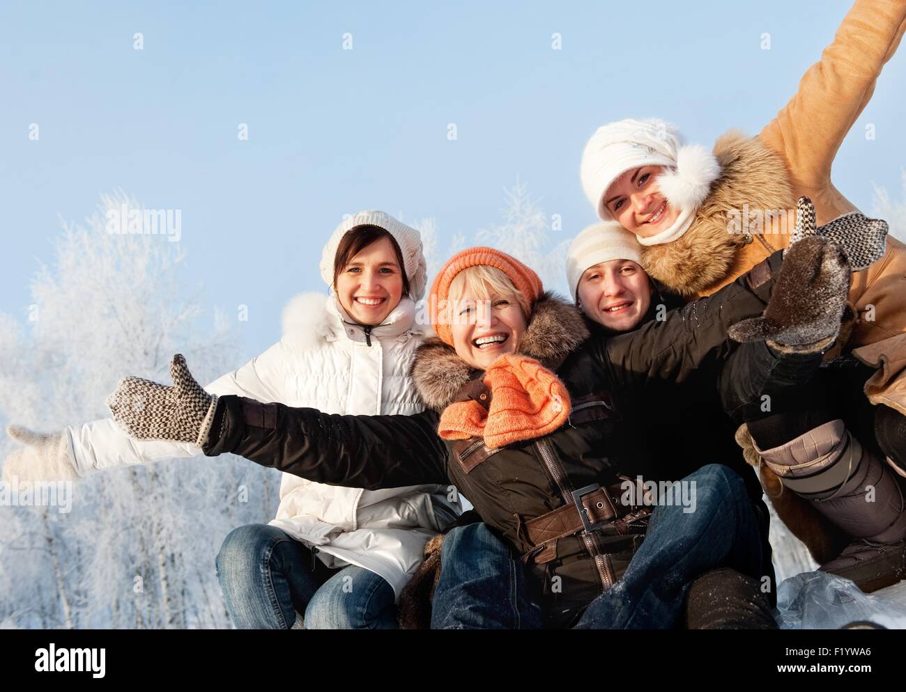 Happy friends on a winter background Stock Photo - Alamy