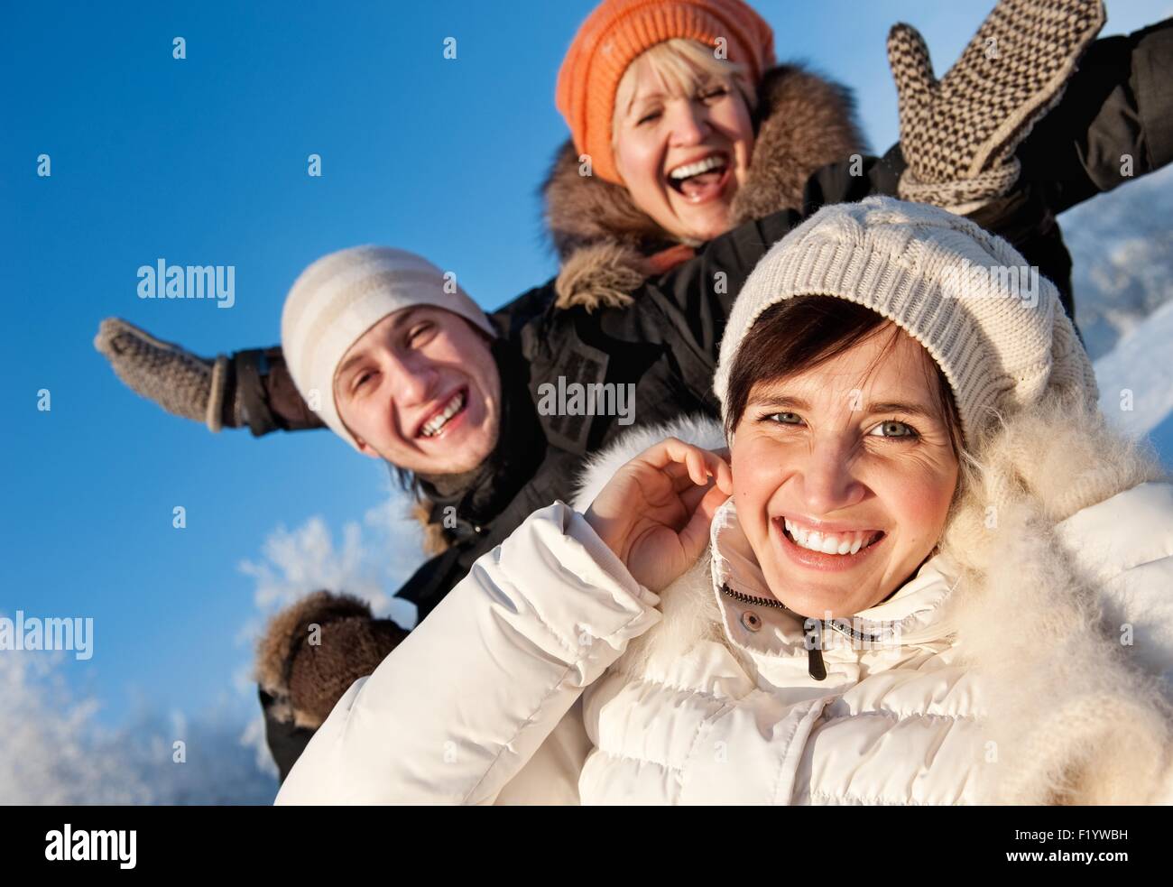 Happy friends on a winter background Stock Photo - Alamy