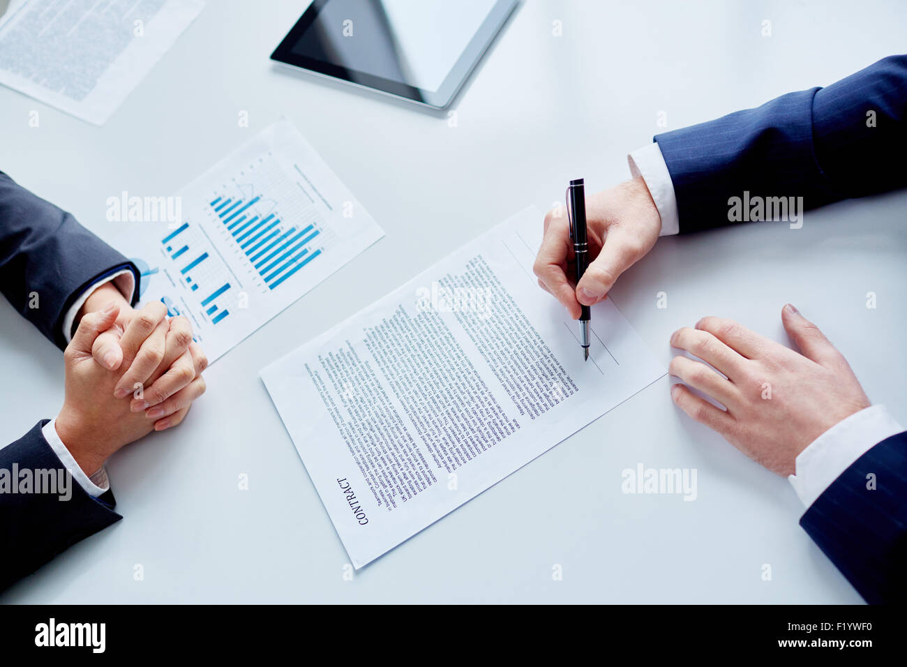 Businessman signing contract after making agreement Stock Photo - Alamy