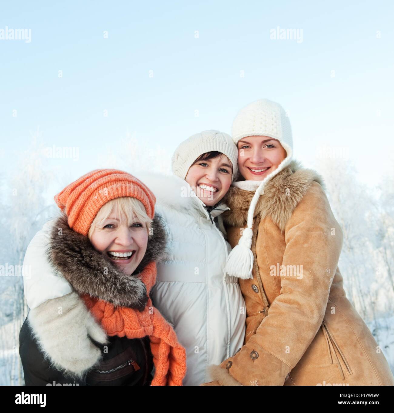 Happy friends on a winter background Stock Photo - Alamy