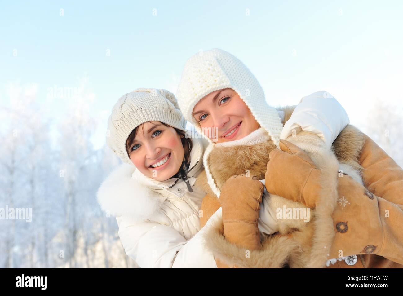 Happy friends on a winter background Stock Photo - Alamy