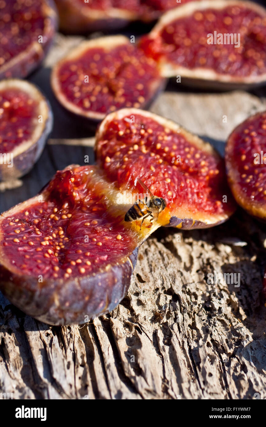 Open figs on wooden surface Stock Photo - Alamy