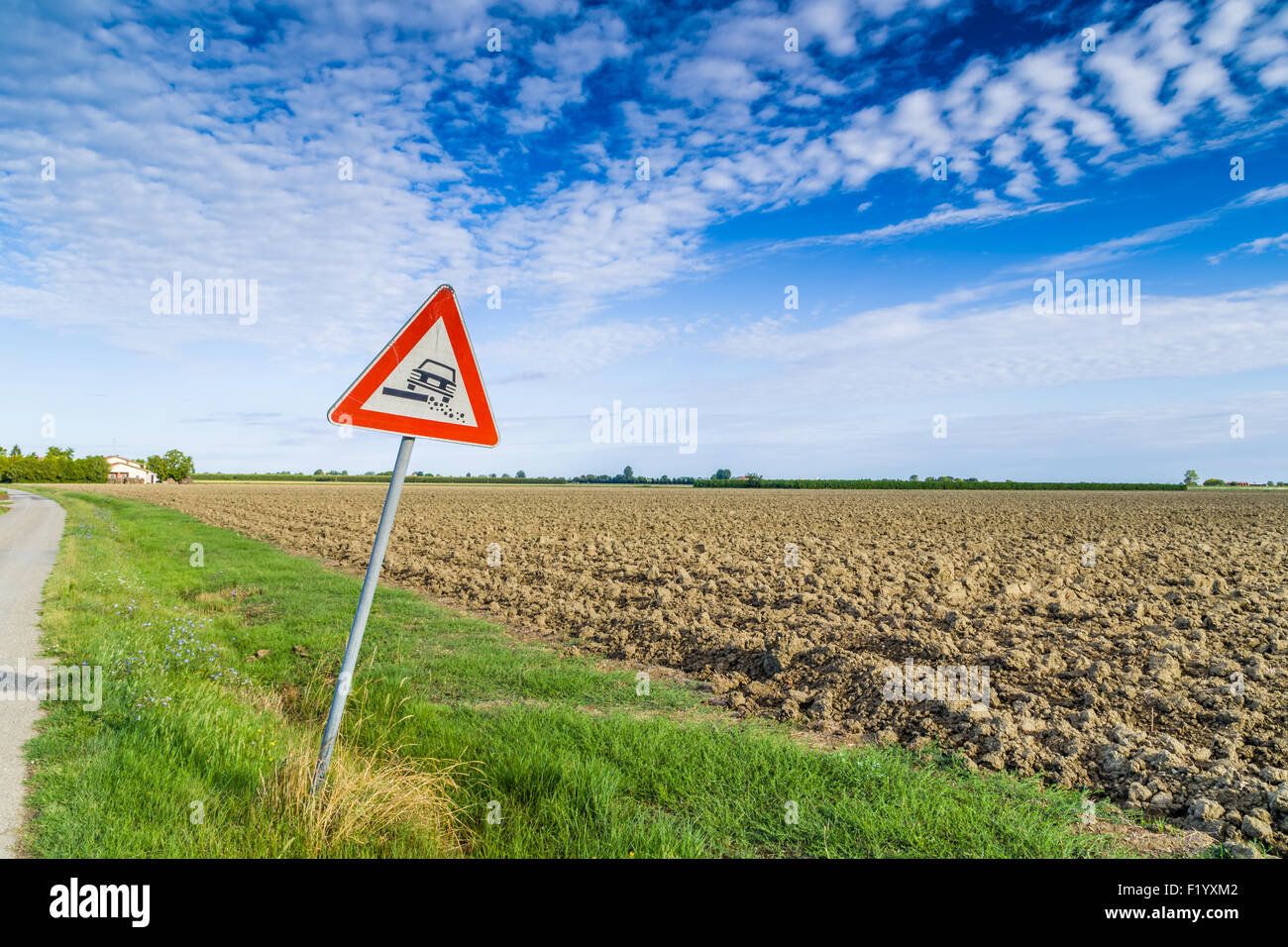 Hazardous Shoulder ruropean road sign along dirt road in Italian ...