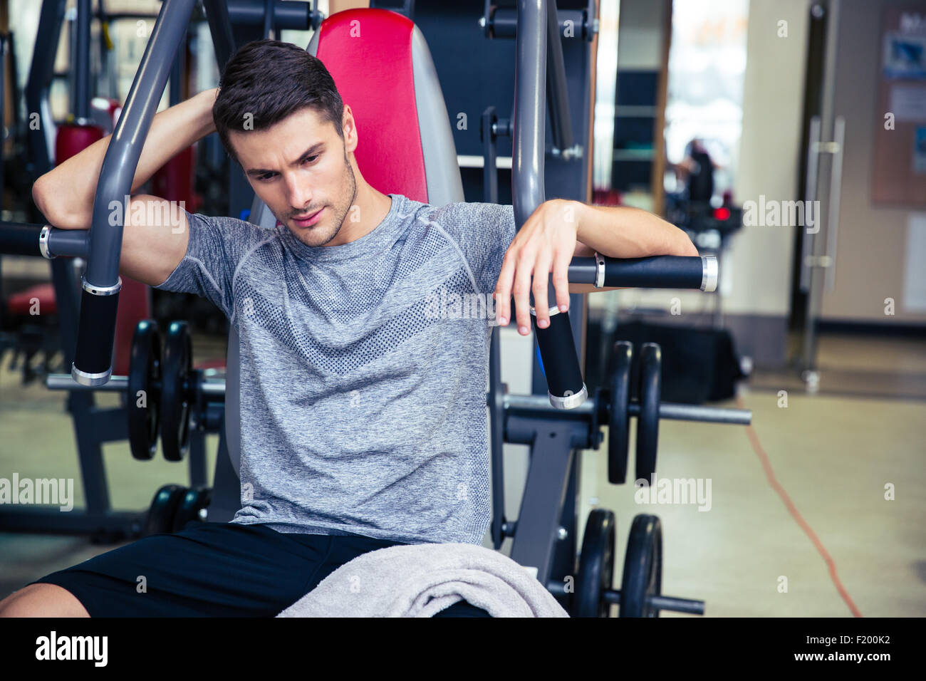 Portrait of a handsome bodybuilder resting at fitness gym Stock Photo ...